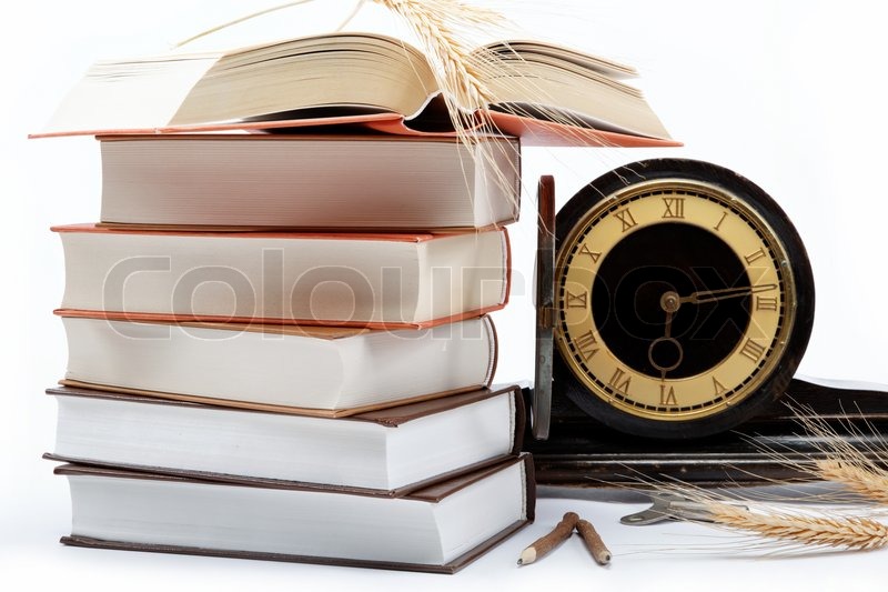 A stack of books and antique clock on a ... | Stock image | Colourbox