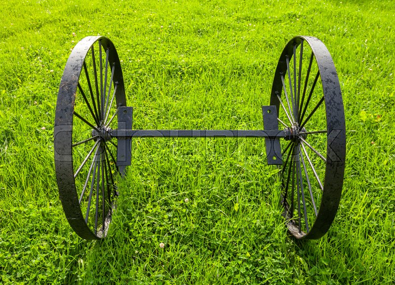 Vintage black metal wheels on one axis ... | Stock image | Colourbox