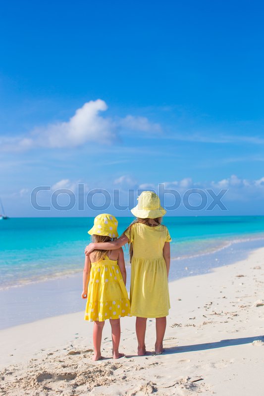 Back view of two sisters looking at the ... | Stock image | Colourbox