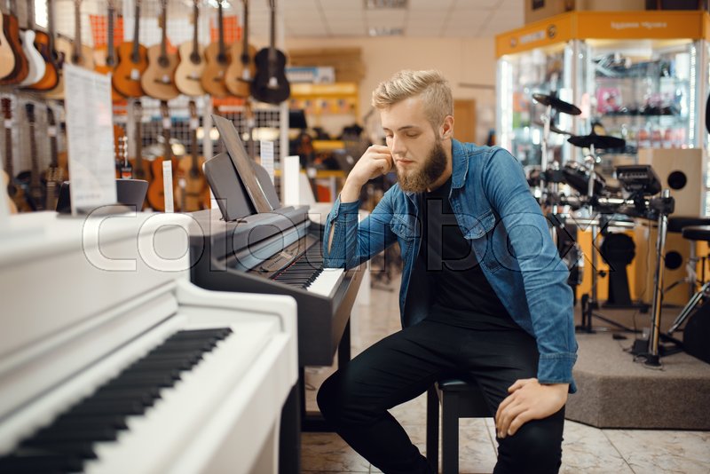 Young male musician poses at the piano ... | Stock image | Colourbox
