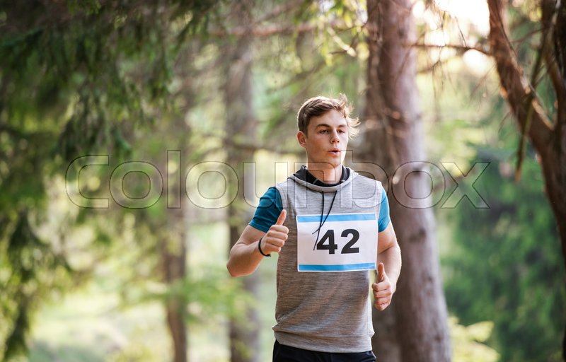A front view of young man running a ... | Stock image | Colourbox