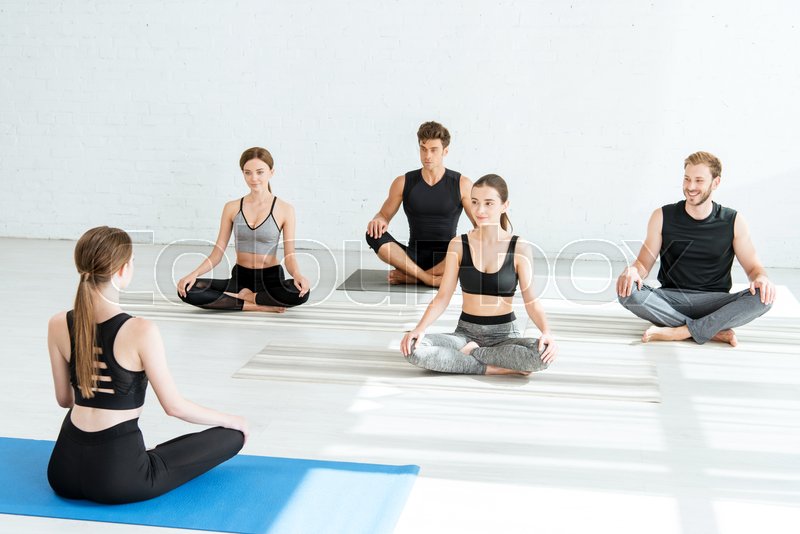 Back view of yoga instructor showing ... | Stock image | Colourbox