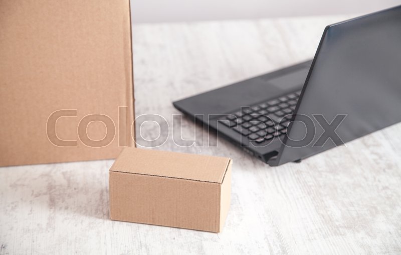 Cardboard boxes with laptop on the ... | Stock image | Colourbox