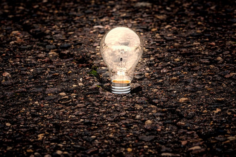 Old light bulb glowing in dark. Ideas ... | Stock image | Colourbox