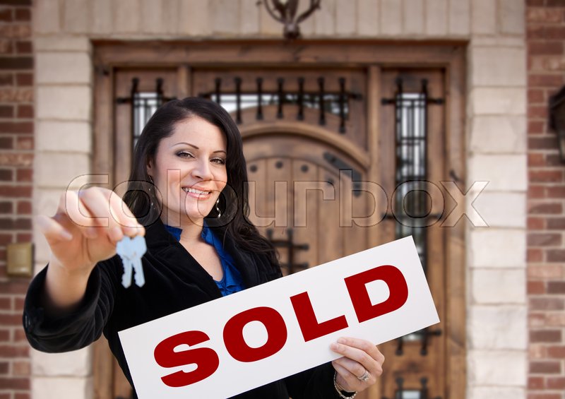 Hispanic Woman Holding Sold Sign and ... | Stock image | Colourbox