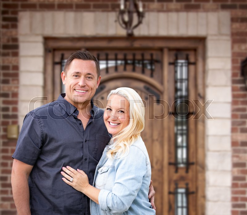 Happy Couple In Front Of House
