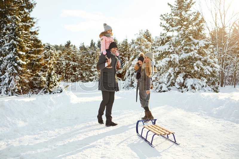 Happy family sledding in the park in ... | Stock image | Colourbox