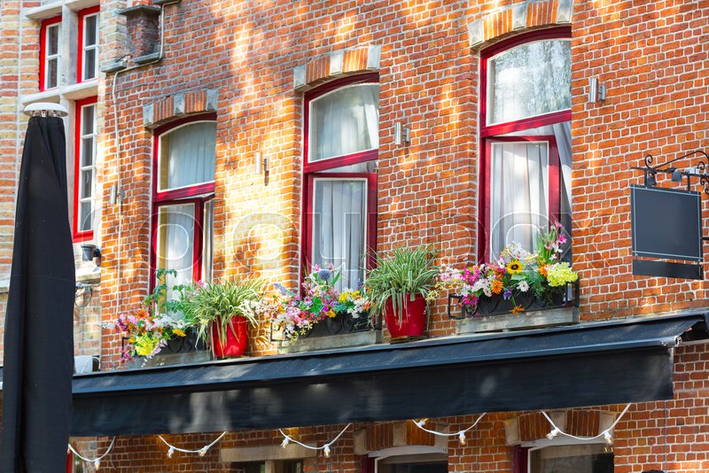 Ancient building facade with flowers, ... | Stock image | Colourbox