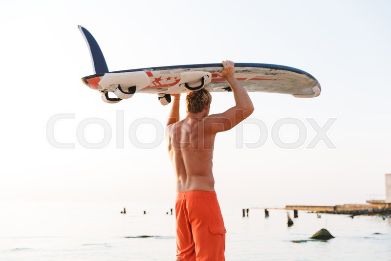 Image of strong young shirtless surfer ... | Stock image | Colourbox
