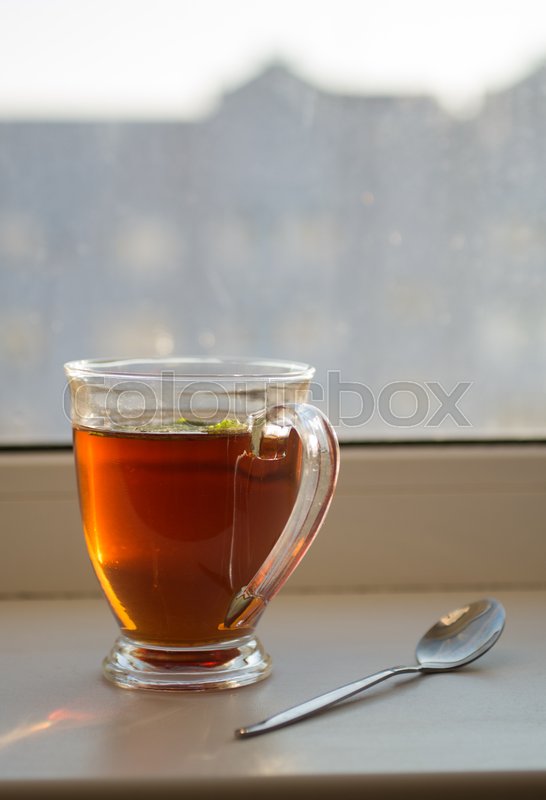 Cup of tea on a window sill | Stock image | Colourbox