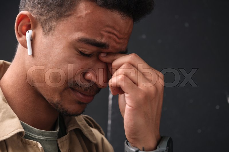 Image of unhappy african american guy ... | Stock image | Colourbox