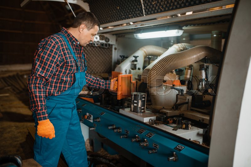 Carpenter in uniform near woodworking ... | Stock image | Colourbox