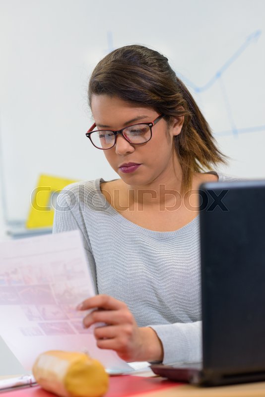 Secretary writing a note | Stock image | Colourbox