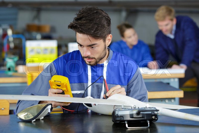 Trainee aircraft engineer using a ... | Stock image | Colourbox