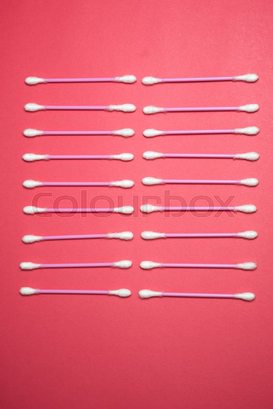 Ear swabs on a pink table. | Stock image | Colourbox