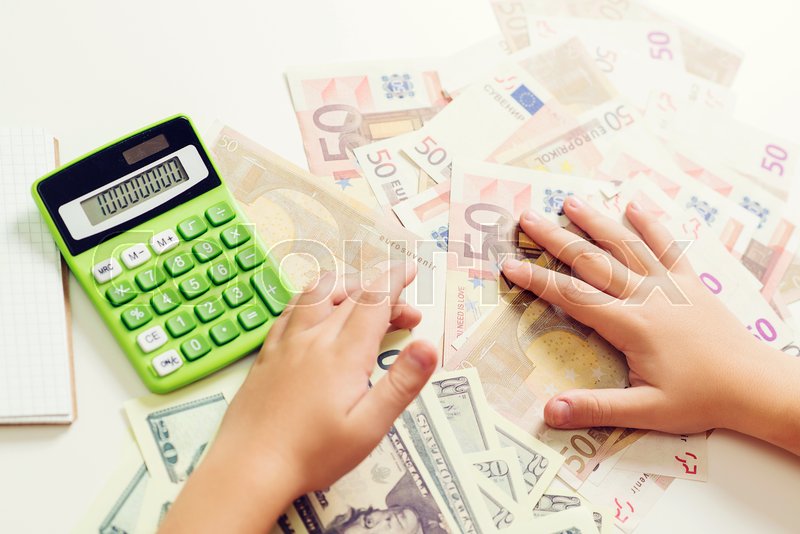 Kid counts money with calculator, top ... | Stock image | Colourbox
