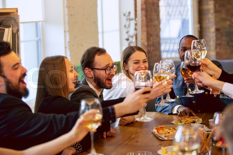 Happy co-workers celebrating while ... | Stock image | Colourbox