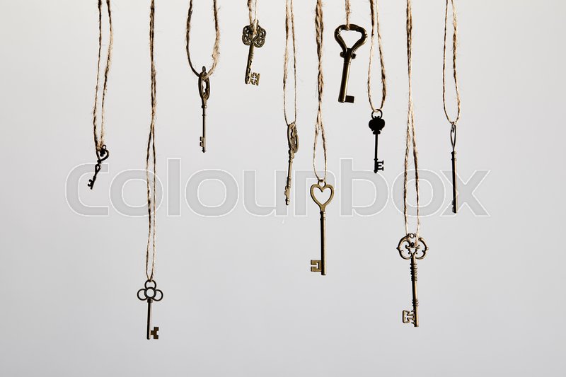 Vintage keys hanging on ropes isolated ... | Stock image | Colourbox