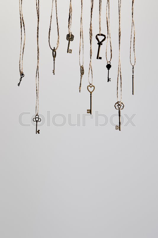 Vintage keys hanging on ropes isolated ... | Stock image | Colourbox
