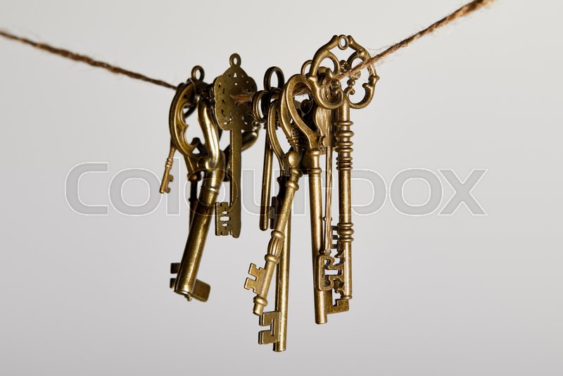 Vintage keys hanging on rope isolated ... | Stock image | Colourbox