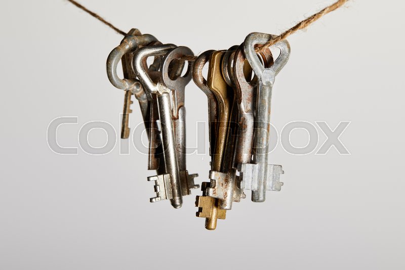 Vintage rusty keys hanging on rope ... | Stock image | Colourbox