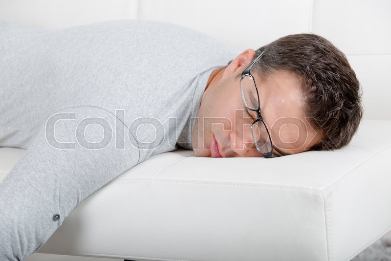 Man snoozing on the sofa | Stock image | Colourbox