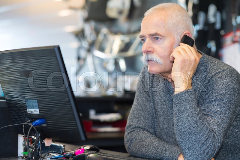 Shop manager having a call conversation | Stock image | Colourbox