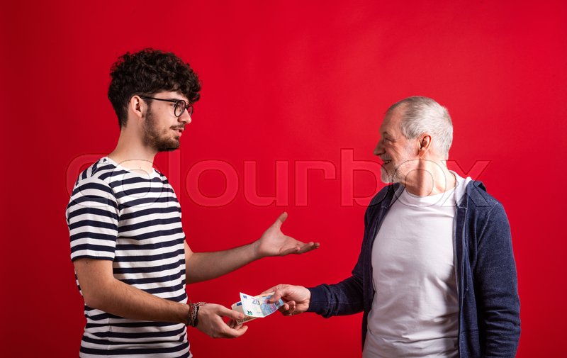 Senior father giving money to his young ... | Stock image | Colourbox