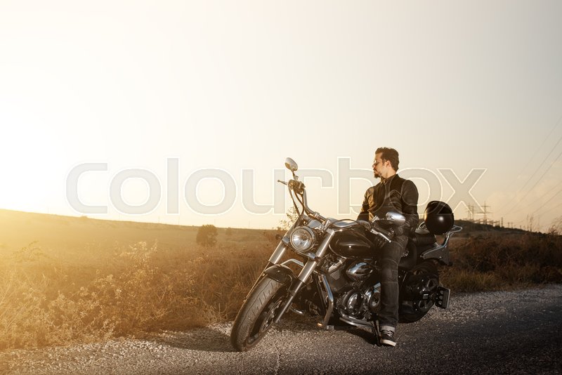 Side view of a young male biker ... | Stock image | Colourbox