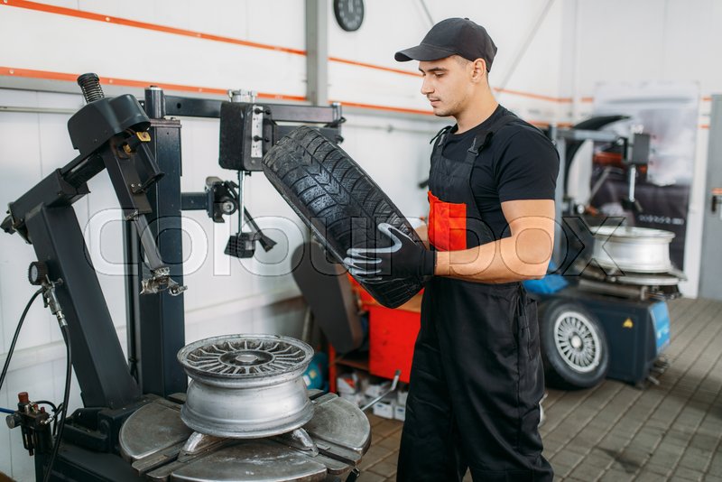 Mechanic change tire, repairing ... | Stock image | Colourbox