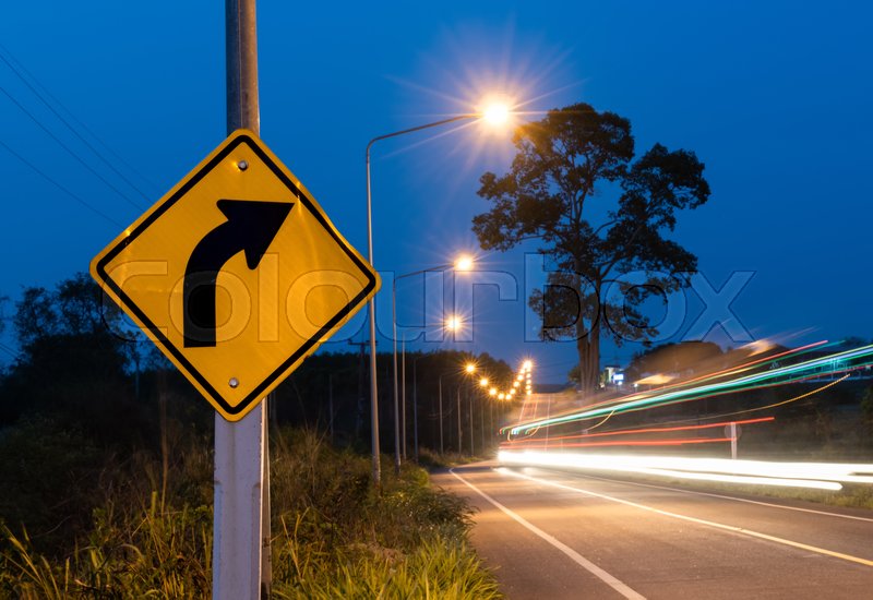 Turn right street sign with car ligh ... | Stock image | Colourbox