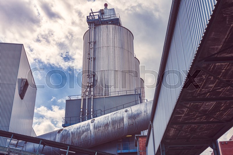 Three silos and a large pipe of a ... | Stock image | Colourbox