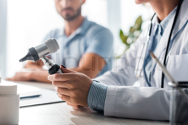 Cropped view of doctor holding otoscope ... | Stock image | Colourbox