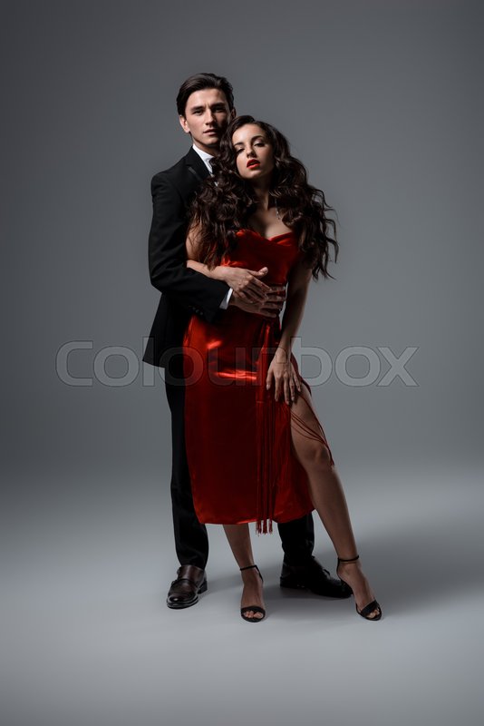 Romantic couple in suit and red silk ... | Stock image | Colourbox