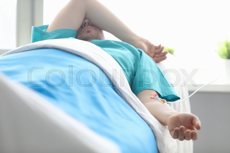 Close-up of man laying in hospital room ... | Stock image | Colourbox
