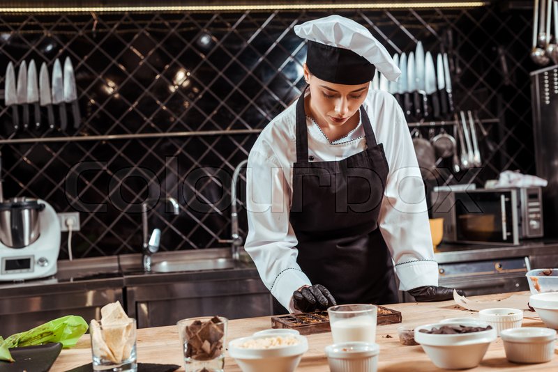 Attractive chocolatier in chef hat ... | Stock image | Colourbox