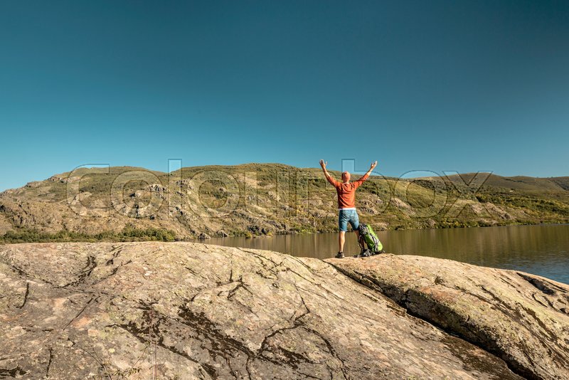 Shot of a man hiking near a beautiful ... | Stock image | Colourbox