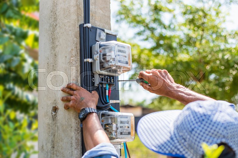 Technician installing electric meter on ... | Stock image | Colourbox