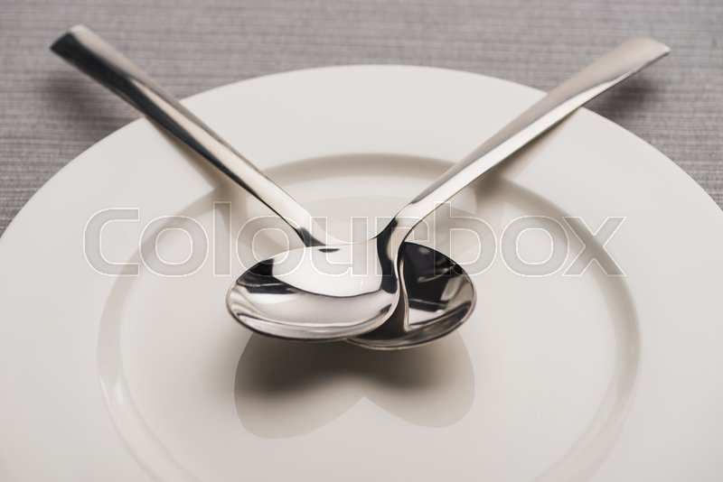 Close up view of spoons on plate on ... | Stock image | Colourbox