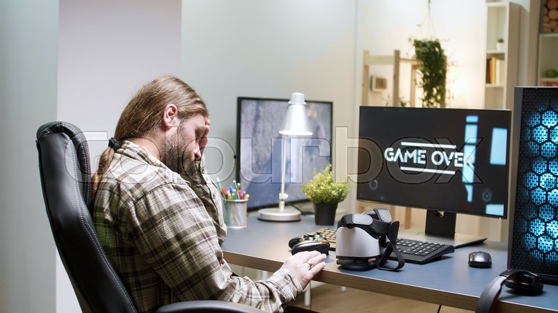 Game over for man sitting on gaming ... | Stock image | Colourbox