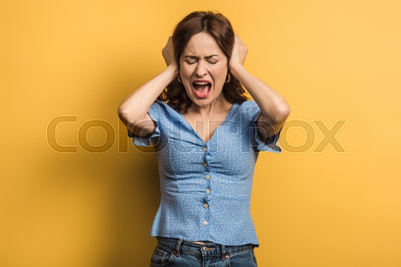 Angry girl screaming while covering ... | Stock image | Colourbox