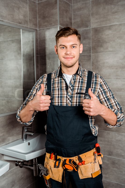 Happy installer with tool belt standing ... | Stock image | Colourbox