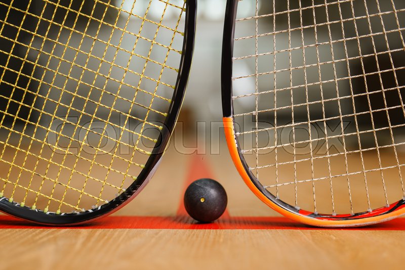 Two squash rackets and ball on court ... | Stock image | Colourbox
