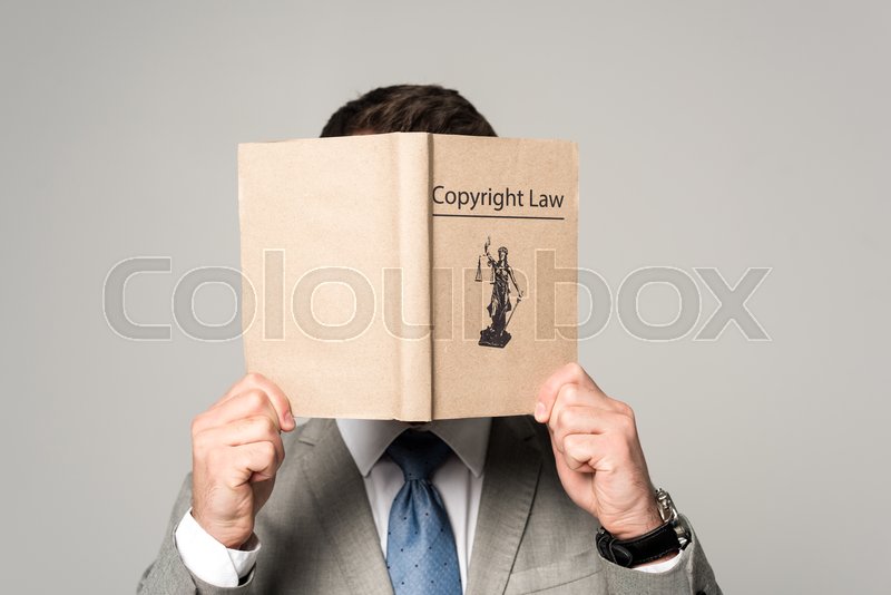 Lawyer obscuring face with copyright ... | Stock image | Colourbox