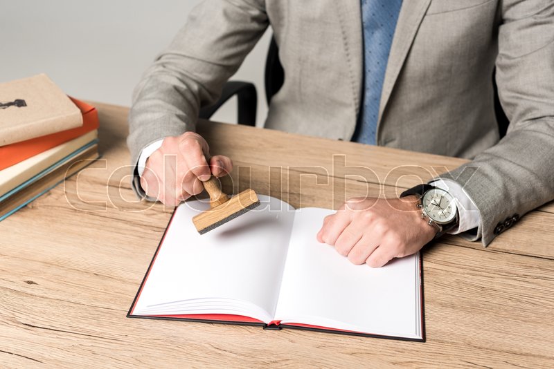 Cropped view of lawyer putting stamp in ... | Stock image | Colourbox