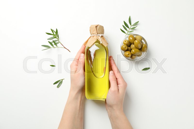 Female hands hold bottle with olive oil ... | Stock image | Colourbox