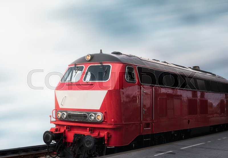 Red train locomotive on rail tracks and ... | Stock image | Colourbox