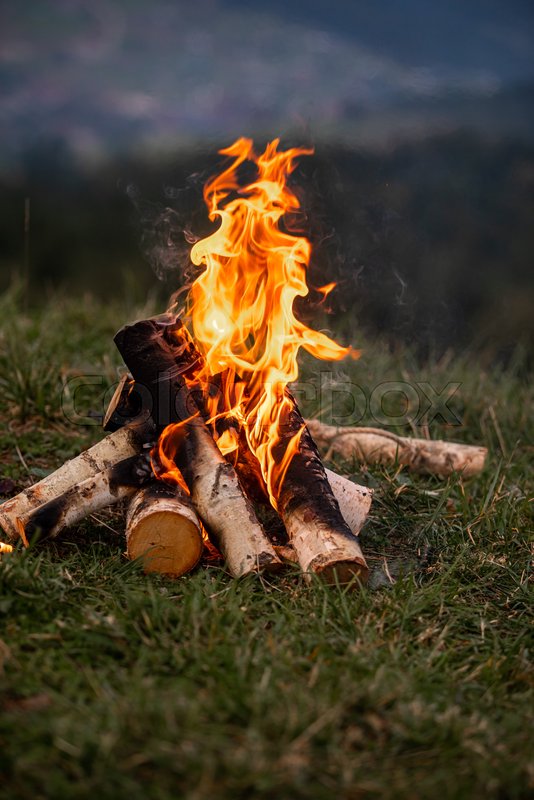 Campfire burns in the mountains in the ... | Stock image | Colourbox