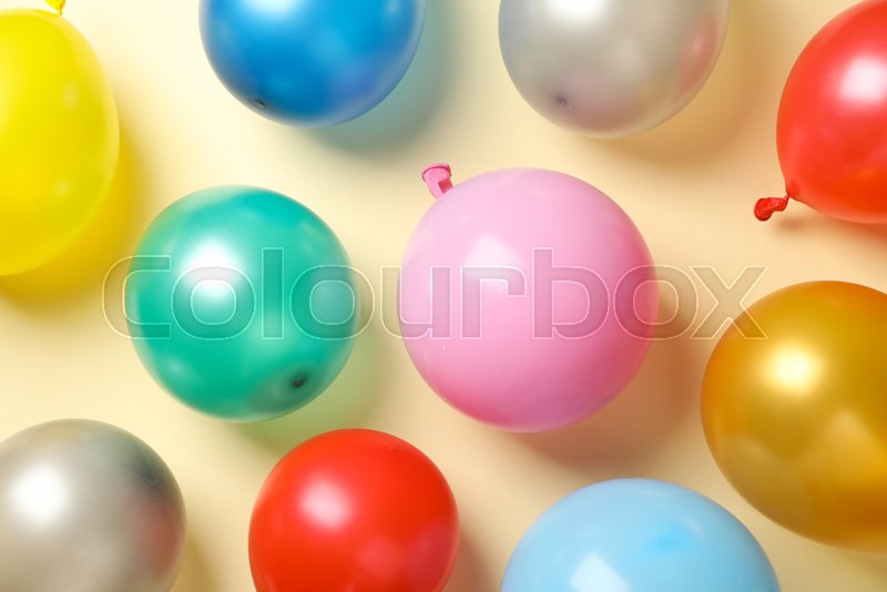 Multicolor balloons on beige ... | Stock image | Colourbox