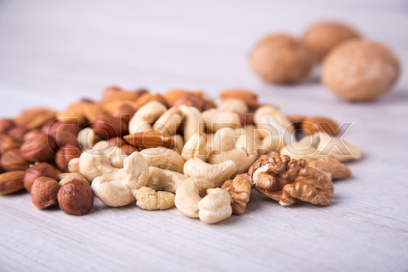 Assortment nuts on wooden table. Close ... | Stock image | Colourbox